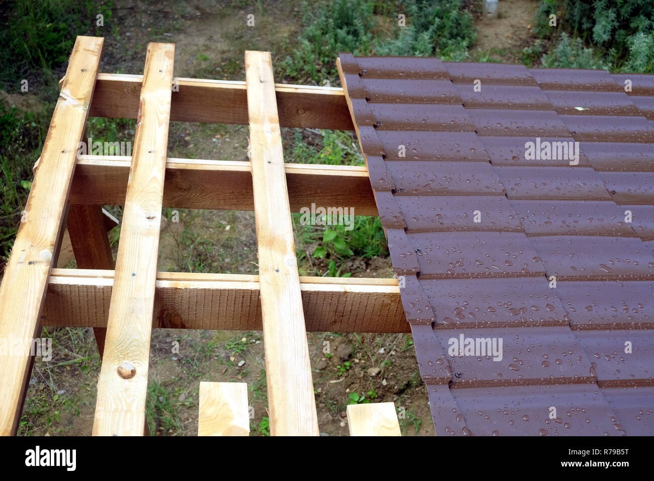 Process of metal roof mounting outside house. Wooden house countryside ...