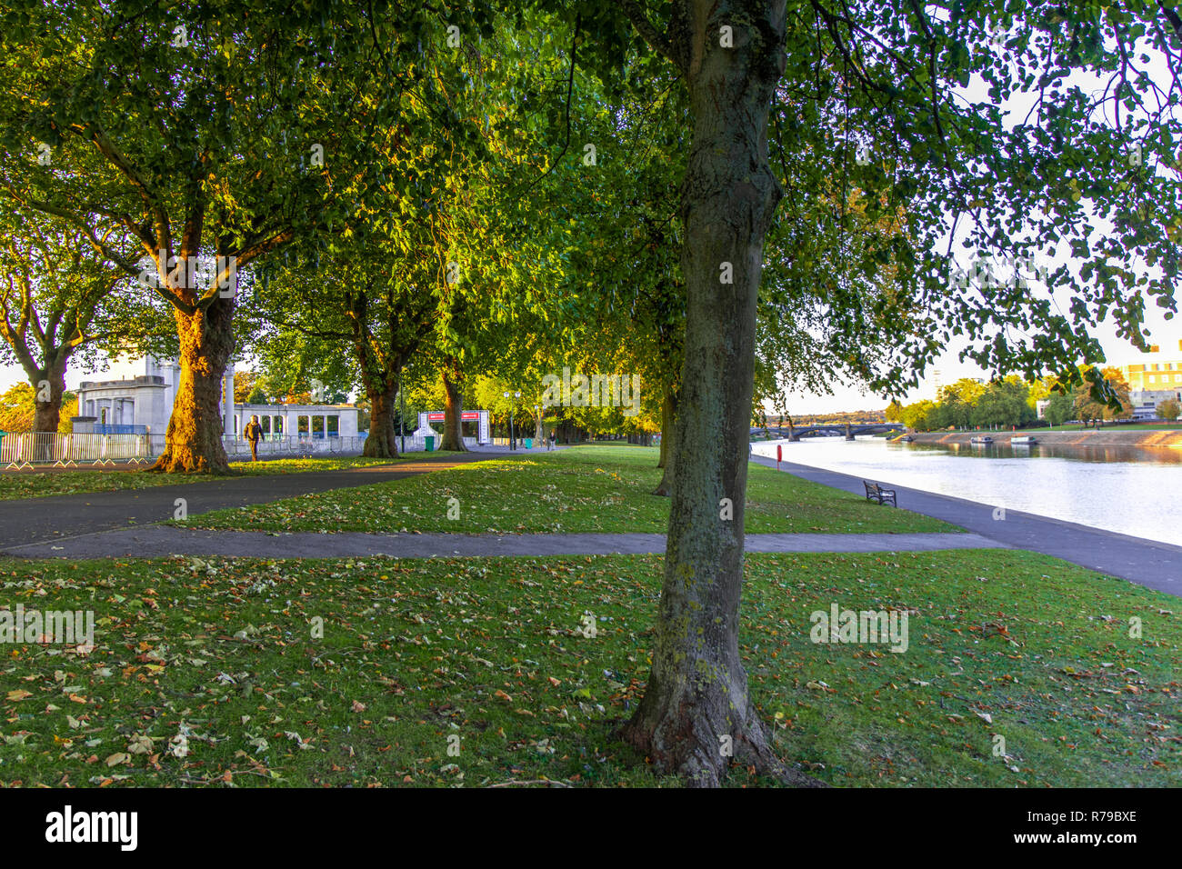 Footpath near large river in UK with trees lined on each side. Victoria ...