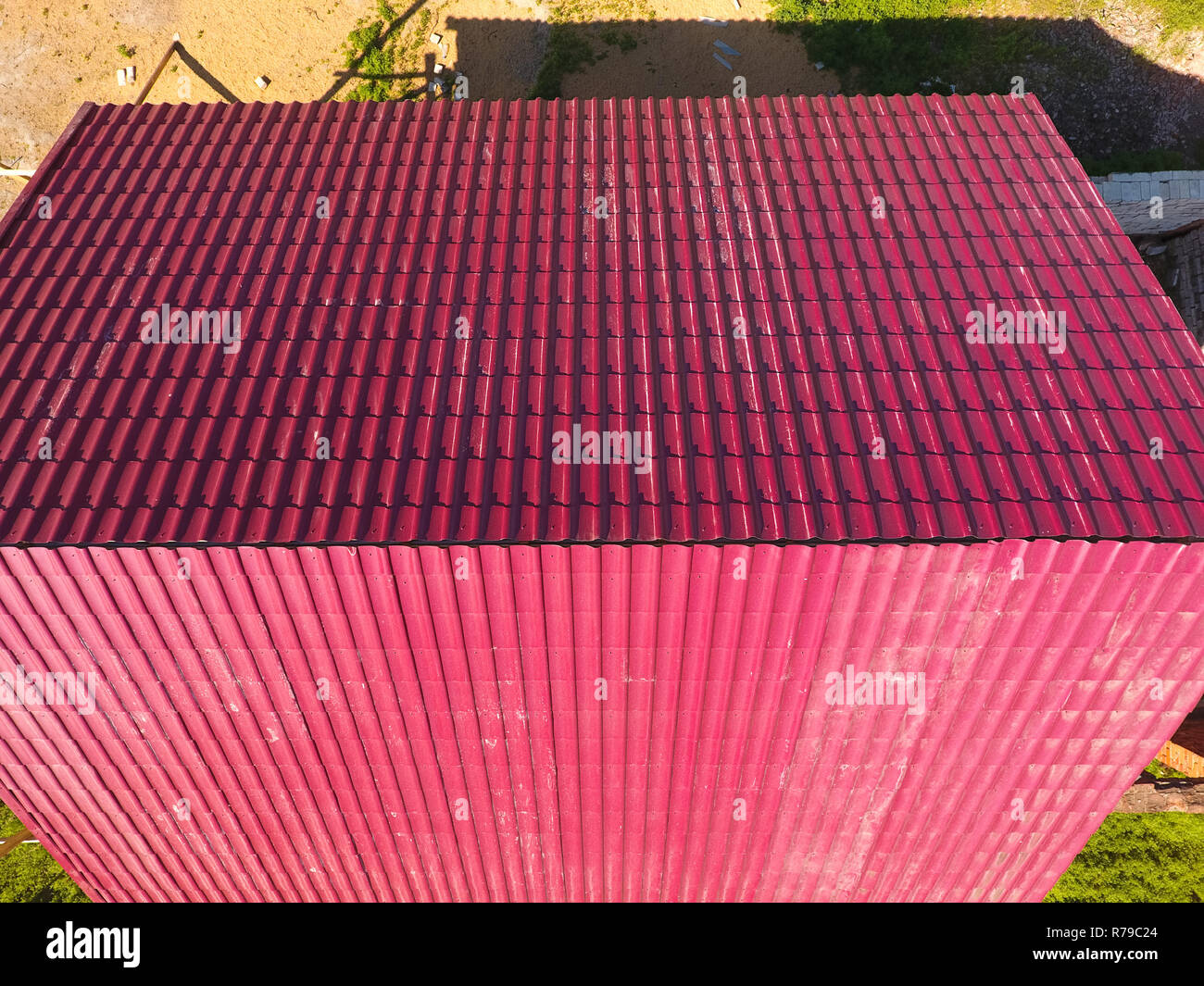 A house with a red roof made of corrugated metal sheets. Roof from ...