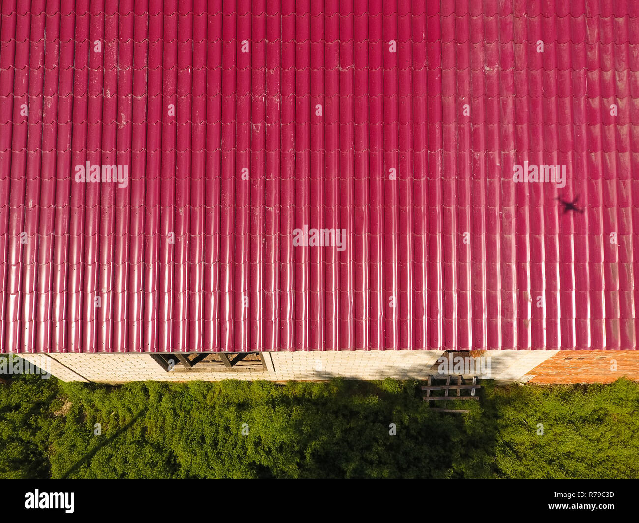 A house with a red roof made of corrugated metal sheets. Roof from ...