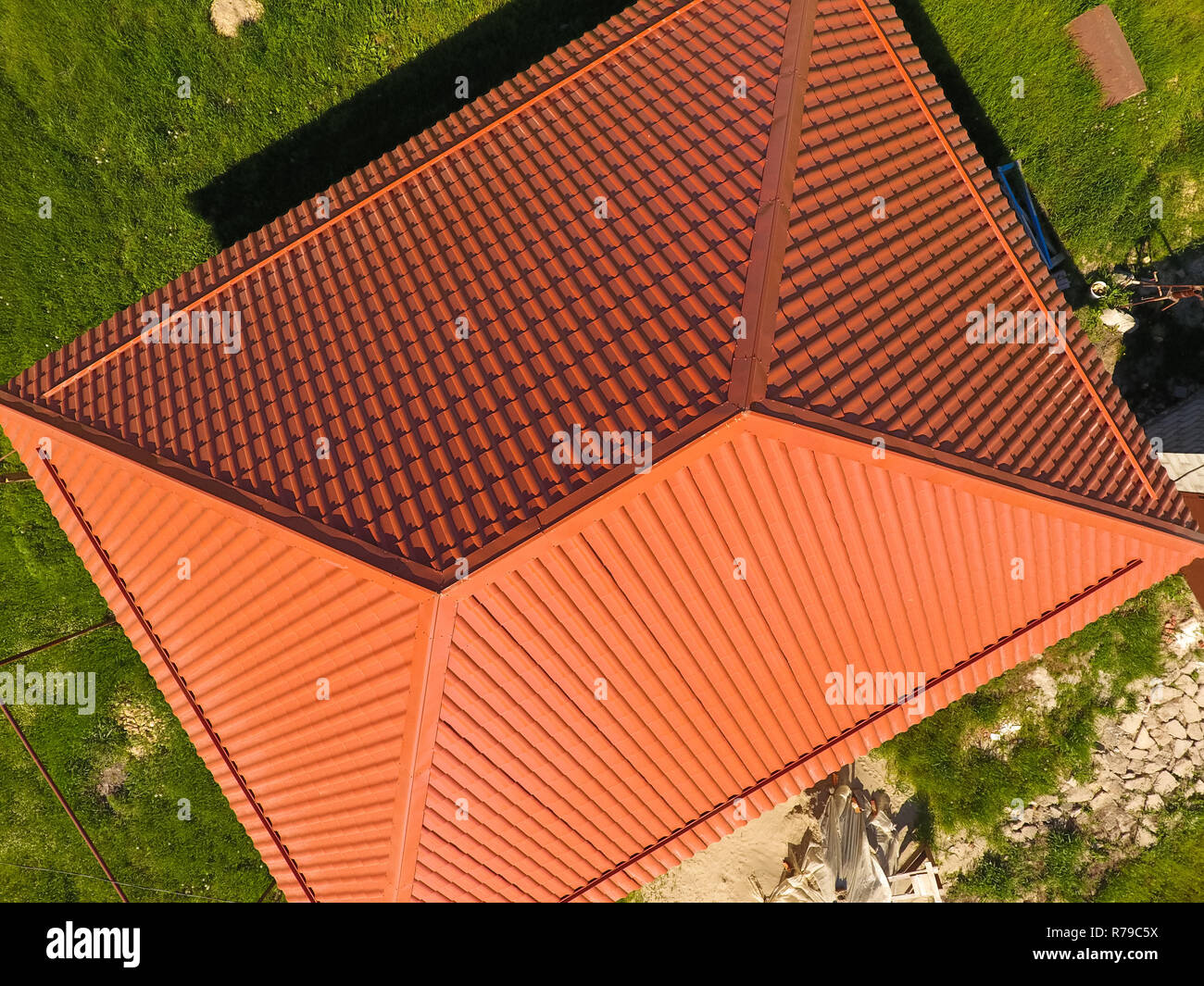 House with an orange roof made of metal, top view. Metallic profile ...