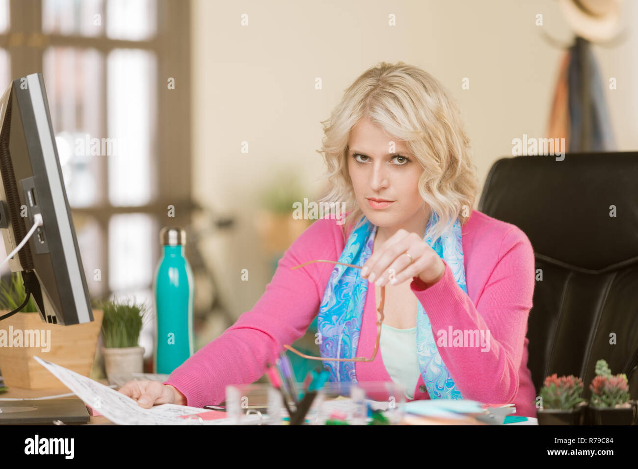 Skeptical Woman at Her Desk Stock Photo - Alamy
