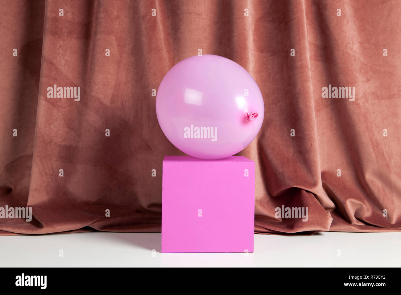 colourful velvet pink balloon cube podium Stock Photo - Alamy