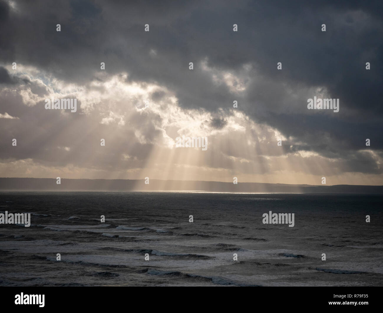 Sunrays emerging through clouds over the Atlantic Ocean coast at ... Sunrays emerging through clouds over the Atlantic Ocean coast at ...