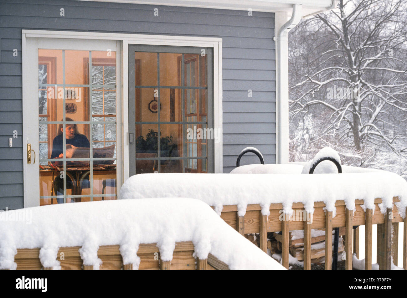 Young woman inside a Cozy House in a Snowstorm, Northeastern USA Stock ...