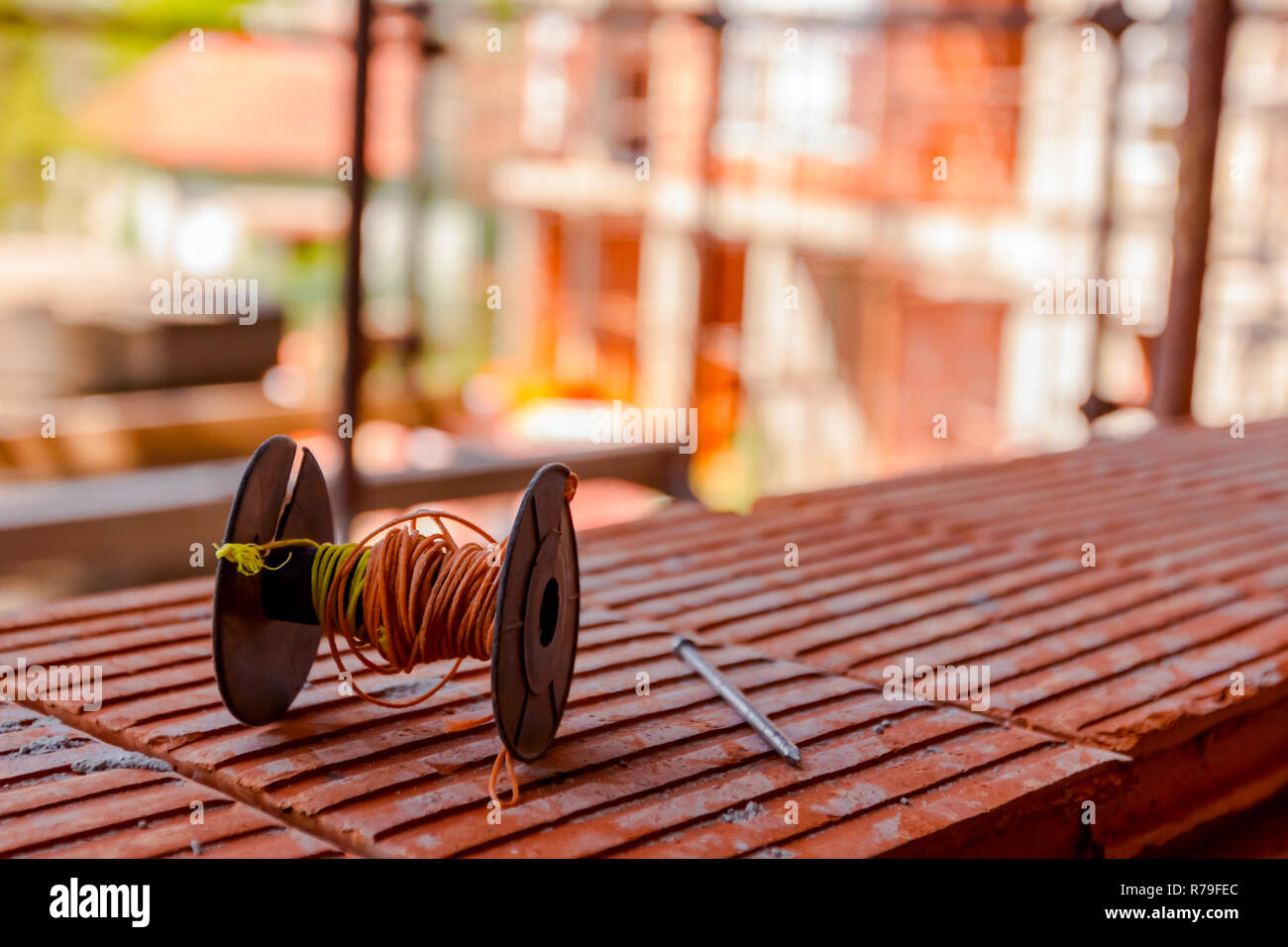 Spool of construction string line is placed on red blocks. Tool to help ...
