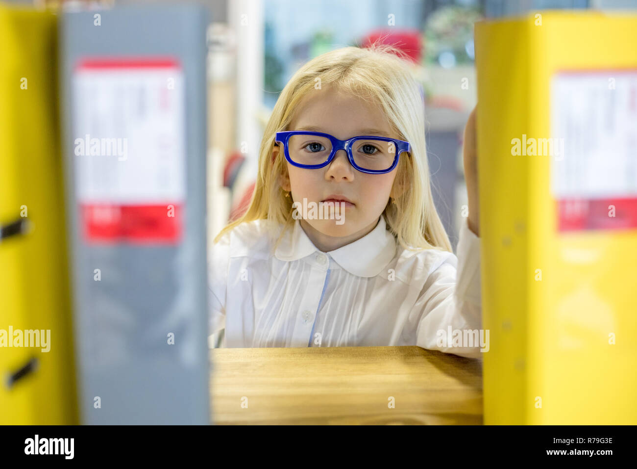 Little girl among the folders with documents. Business children Stock ...
