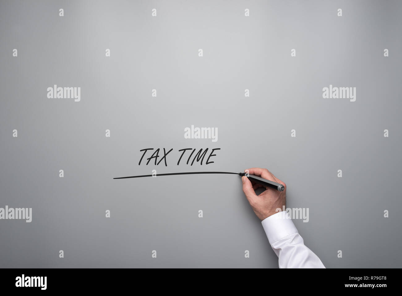 Male hand writing a Text time text with black marker over grey ...