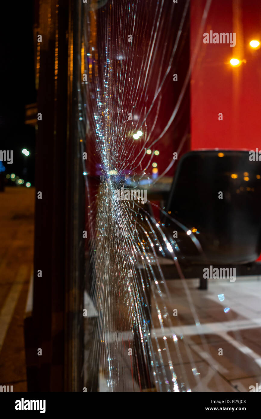 Broken and shattered glass window pane in a shop door at night Stock ...