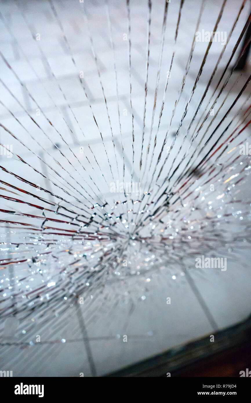 Broken and shattered glass window pane in a shop door Stock Photo - Alamy