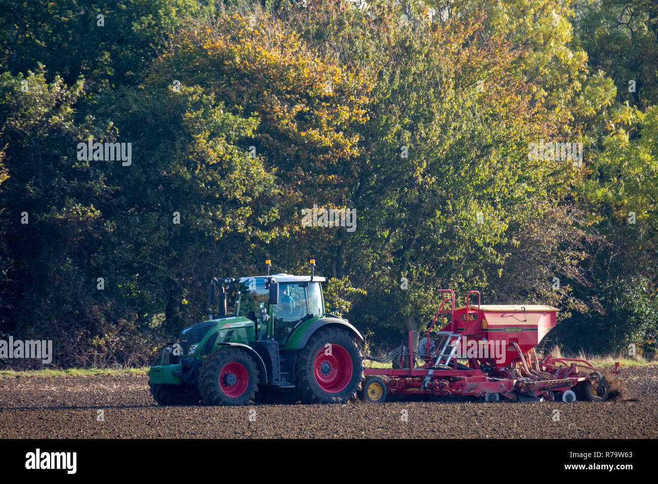 Tractor and Seed Driller planting field in autumn Stock Photo - Alamy