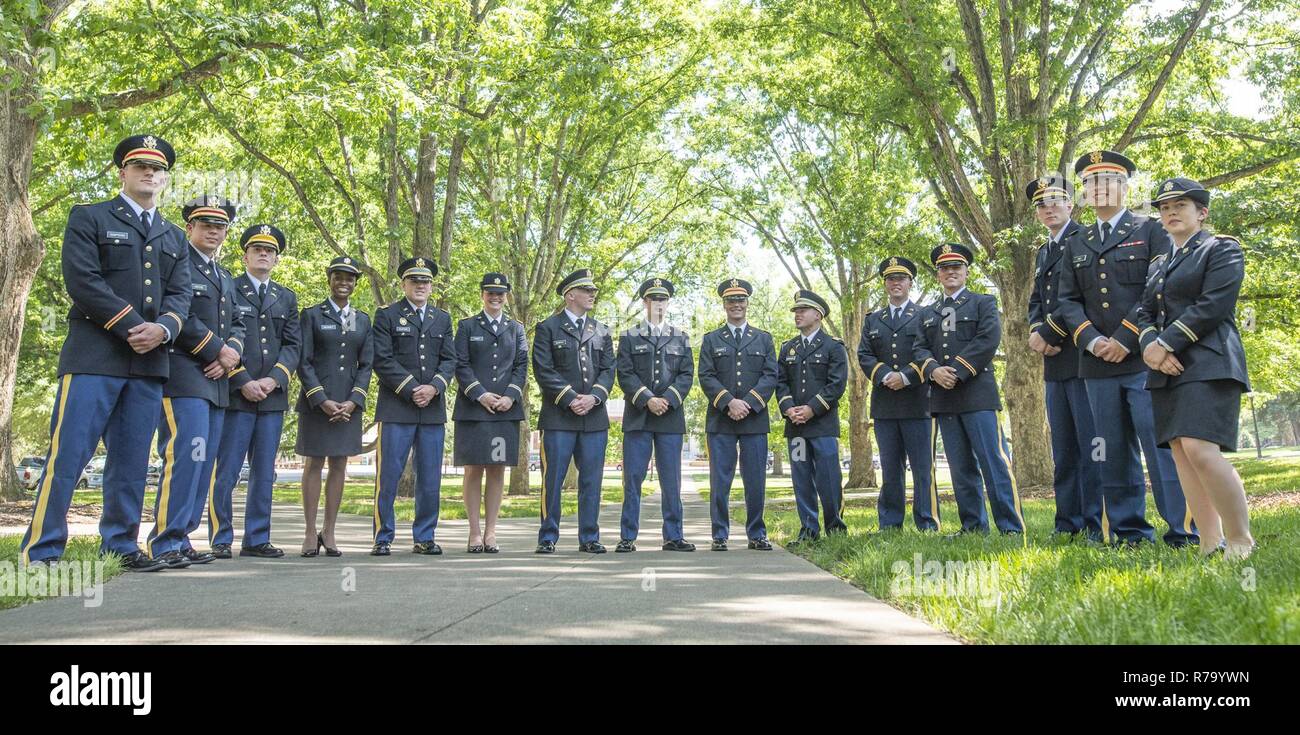Fifteen brand new U.S. Army second lieutenants gather under the trees ...