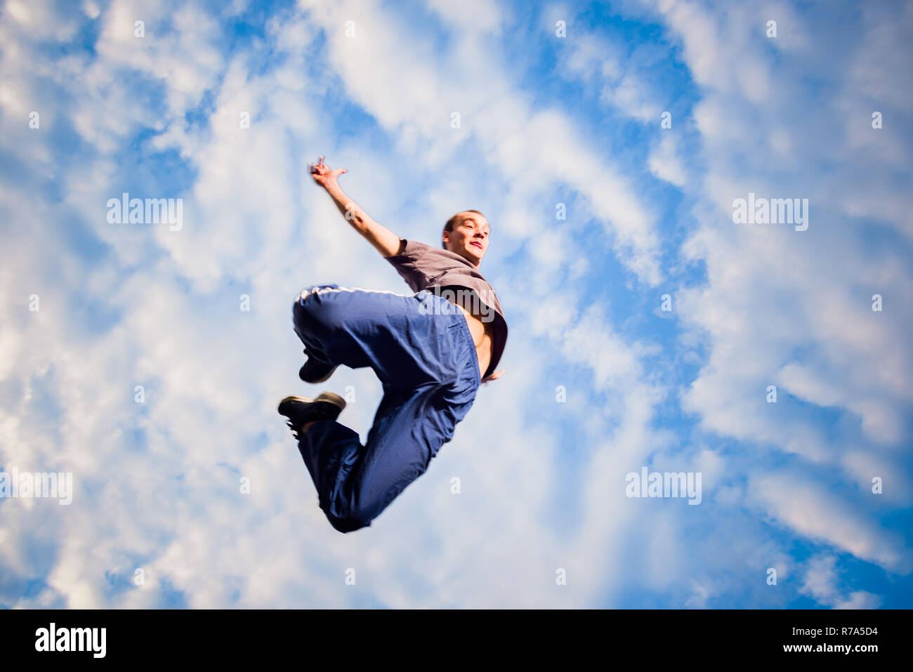 Free runner trains parkour while jumping in the air Stock Photo - Alamy