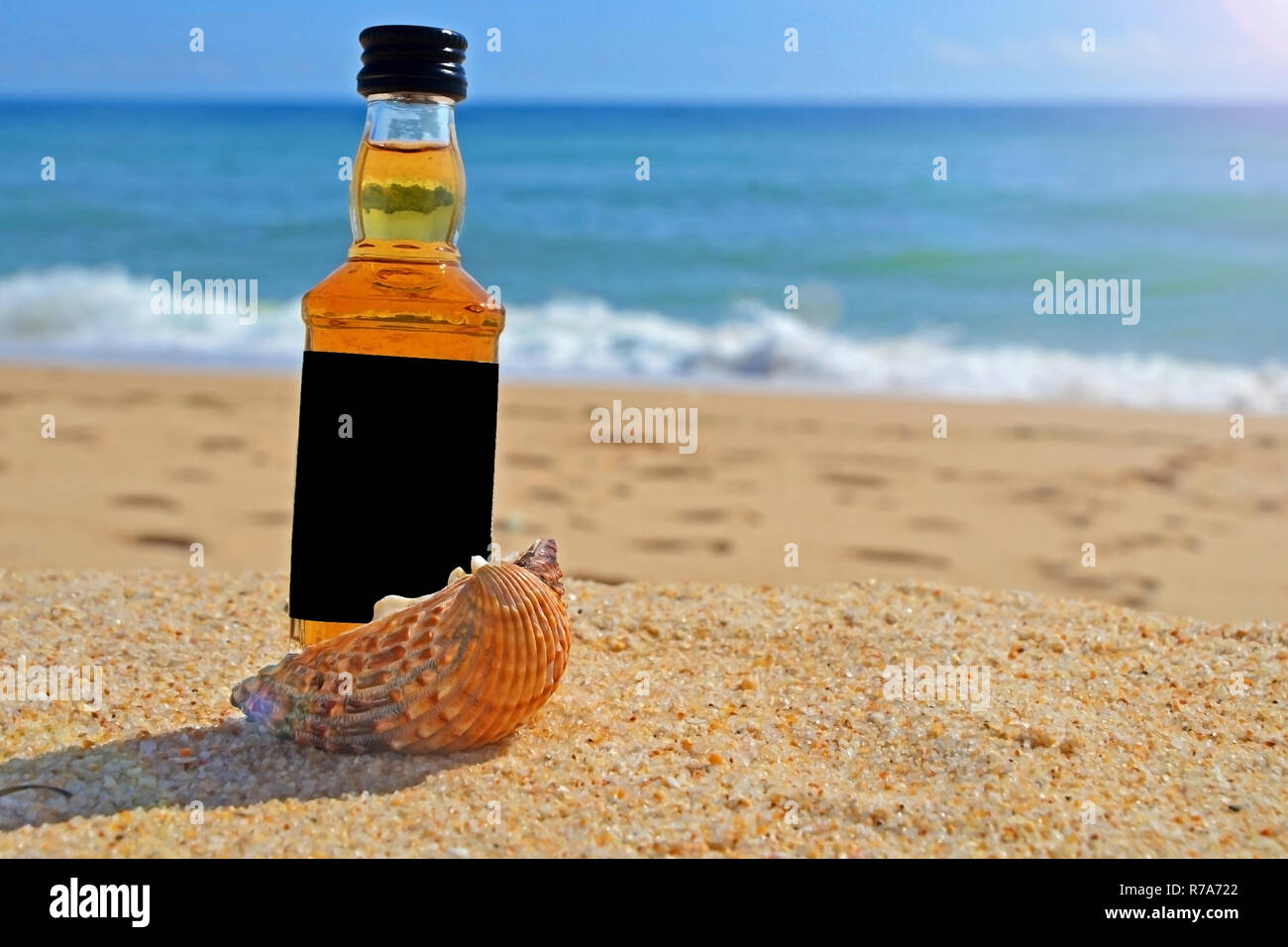 Empty bottle alcohol on beach hi-res stock photography and images - Alamy