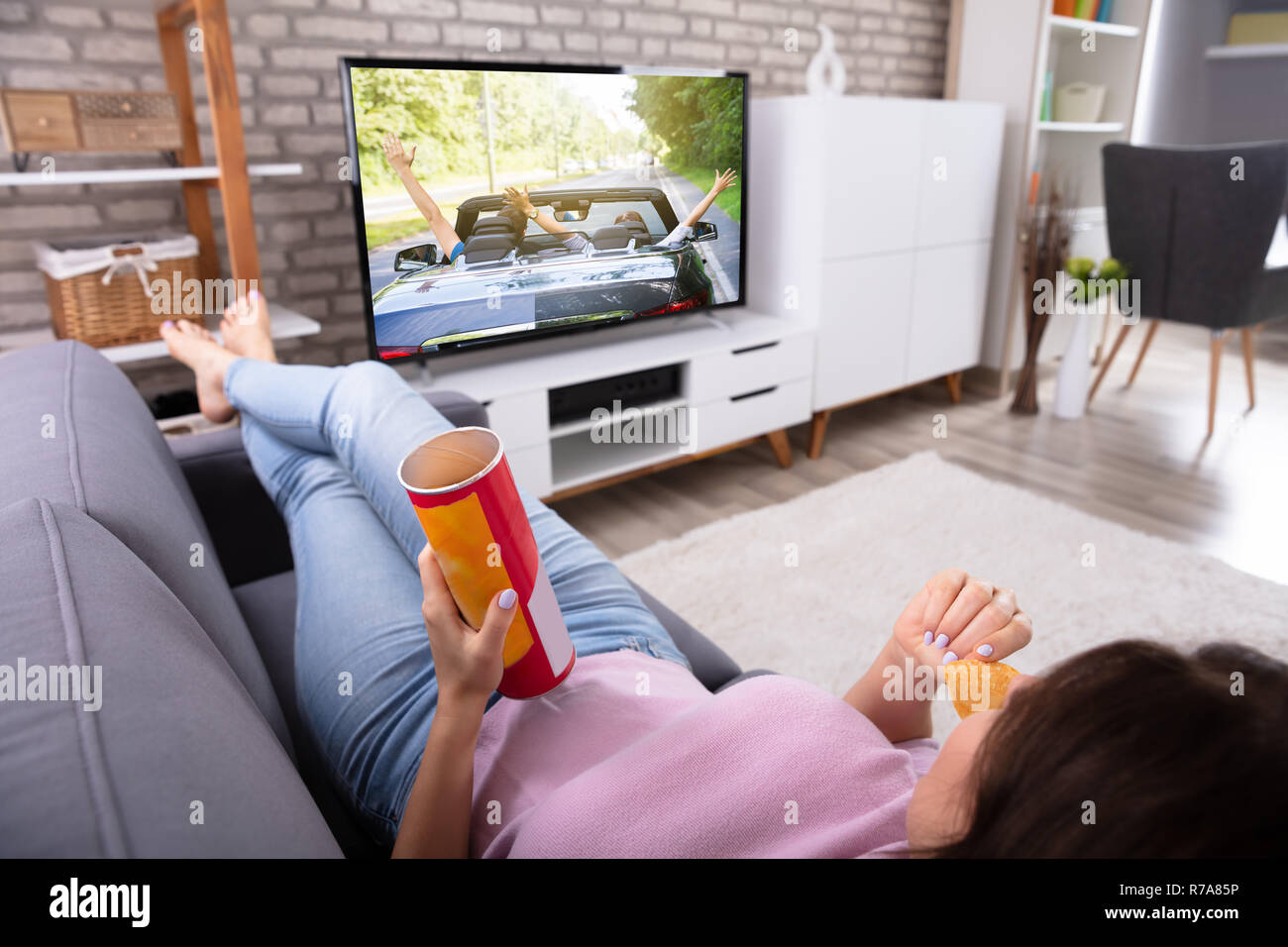 Woman lazy home tv hi-res stock photography and images - Alamy