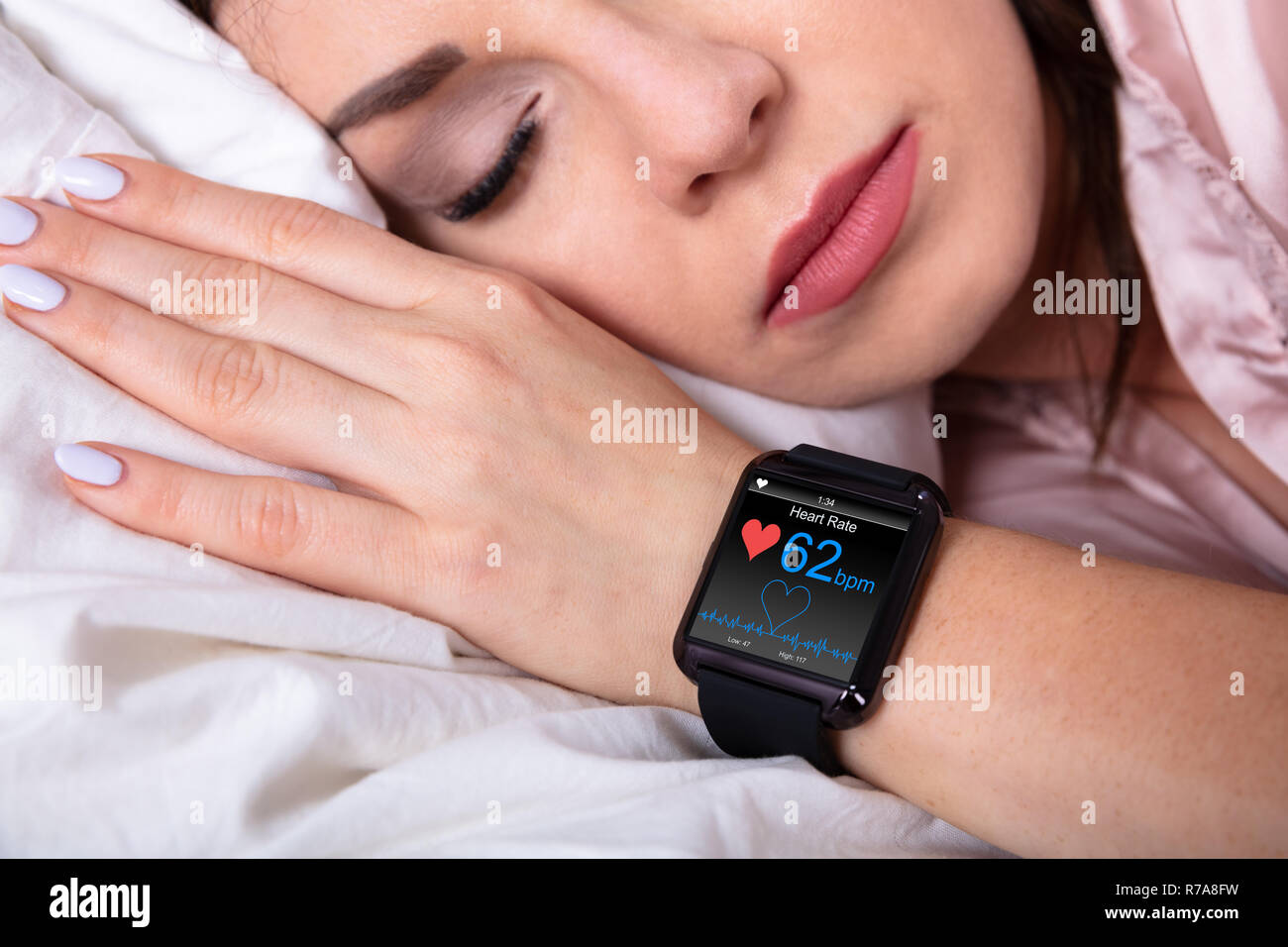 Beautiful Woman Sleeping On Bed With Smartwatch Showing Heartbeat Rate ...
