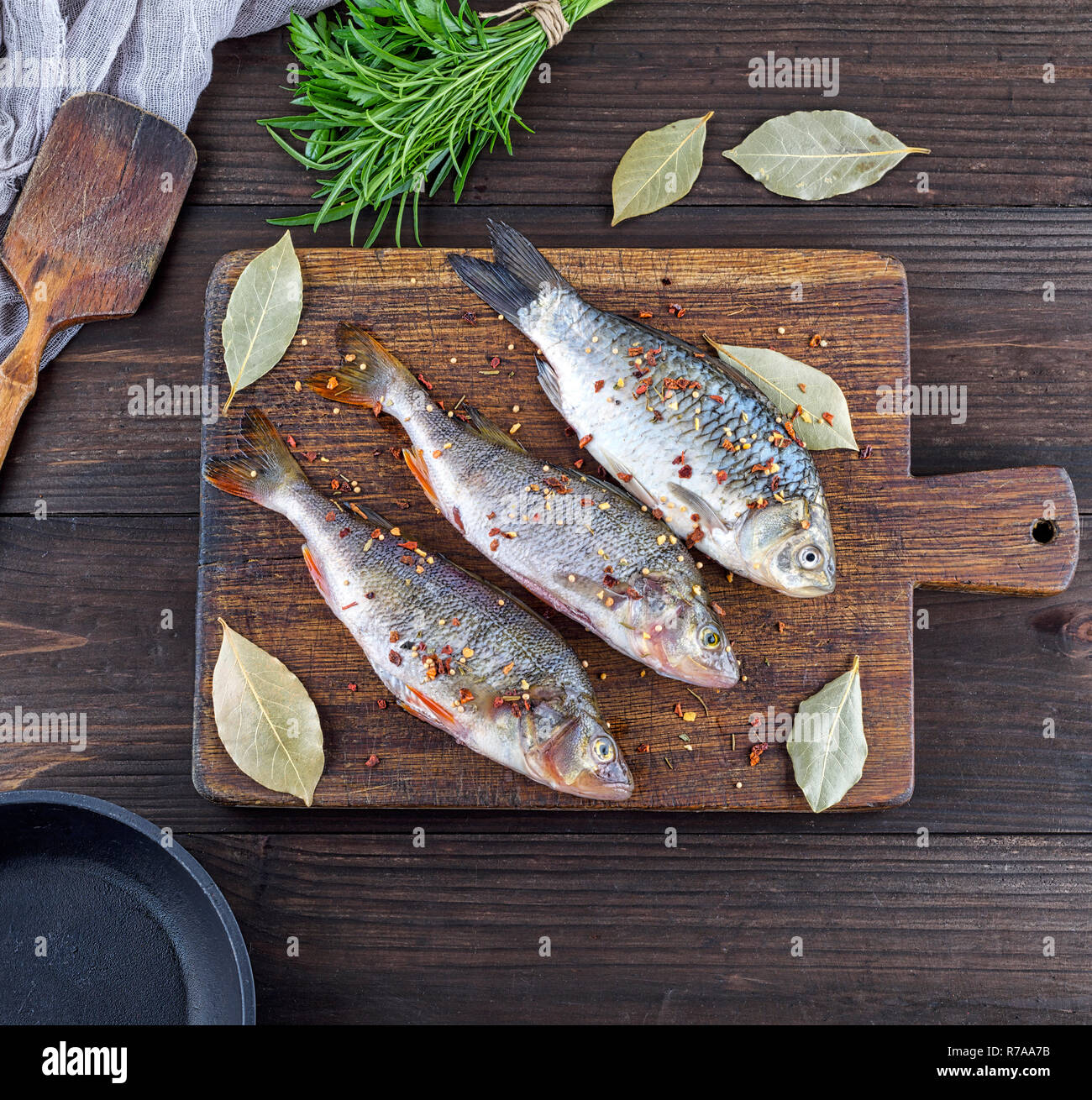 three peeled river fish with spices Stock Photo - Alamy