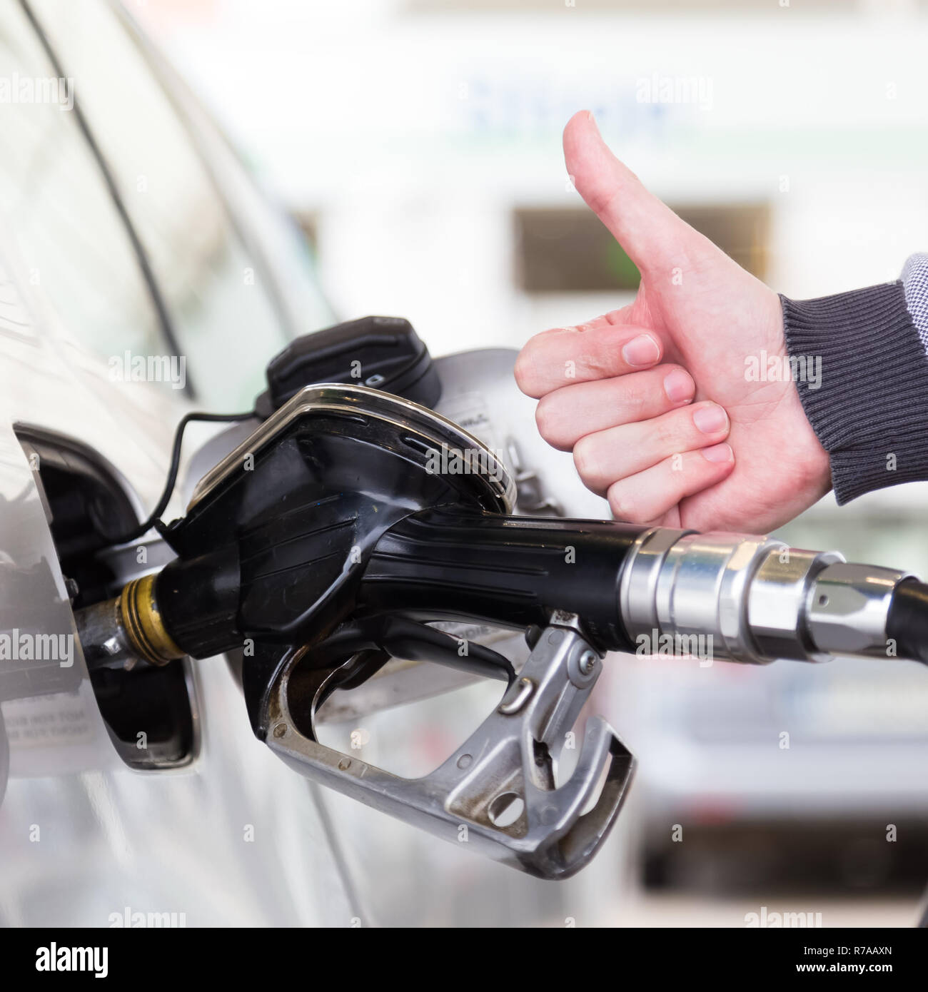 Petrol or gasoline being pumped into a motor vehicle car. Closeup of ...