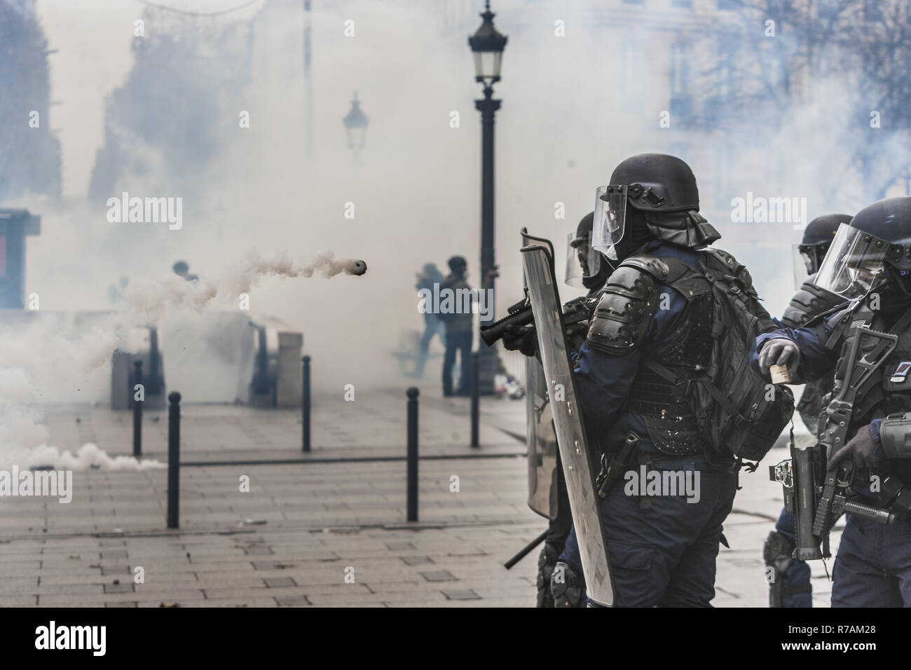 France. 8th Dec, 2018. Riot police surrounded of tear gas during the ...
