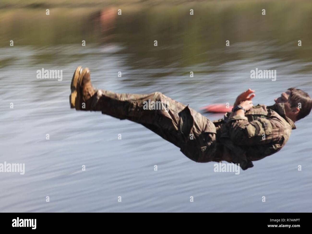 A U.S. Army Ranger slides into Victory Pond during the combat water ...
