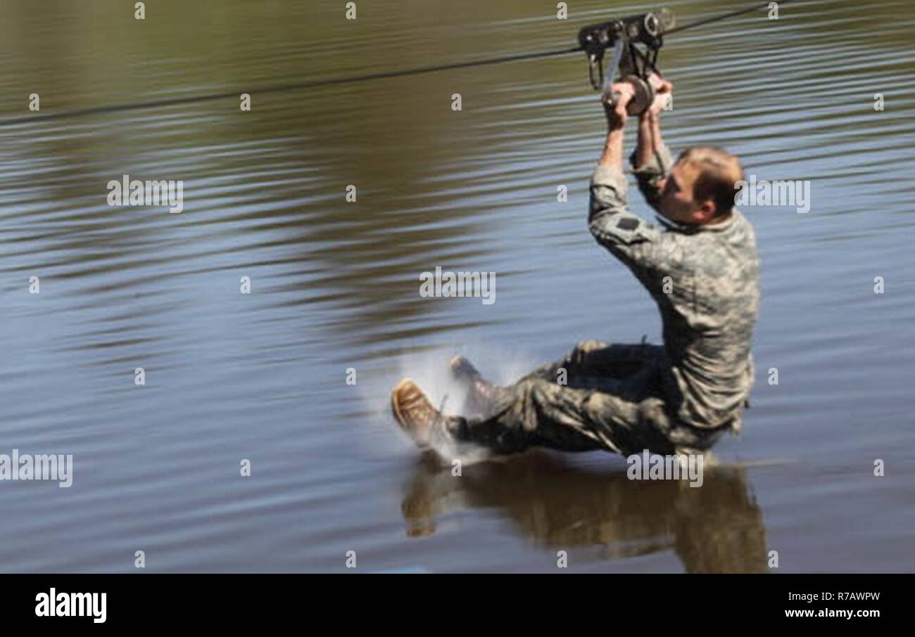 A U.S. Army Ranger slides into Victory Pond during the water survival ...
