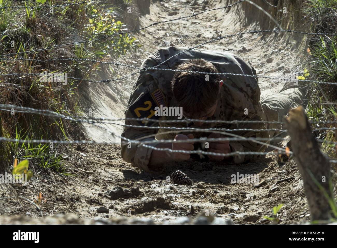 U.S. Army Capt. Michael Hauser, 7th Infantry Division, low-crawls under ...