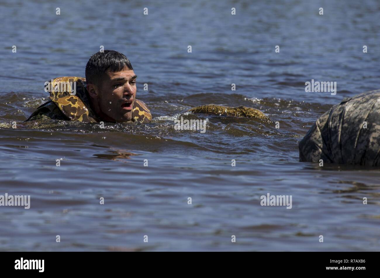 U.S. Army Ranger Capt. Timothy Cox, 3rd Chemical Brigade, swims ashore ...