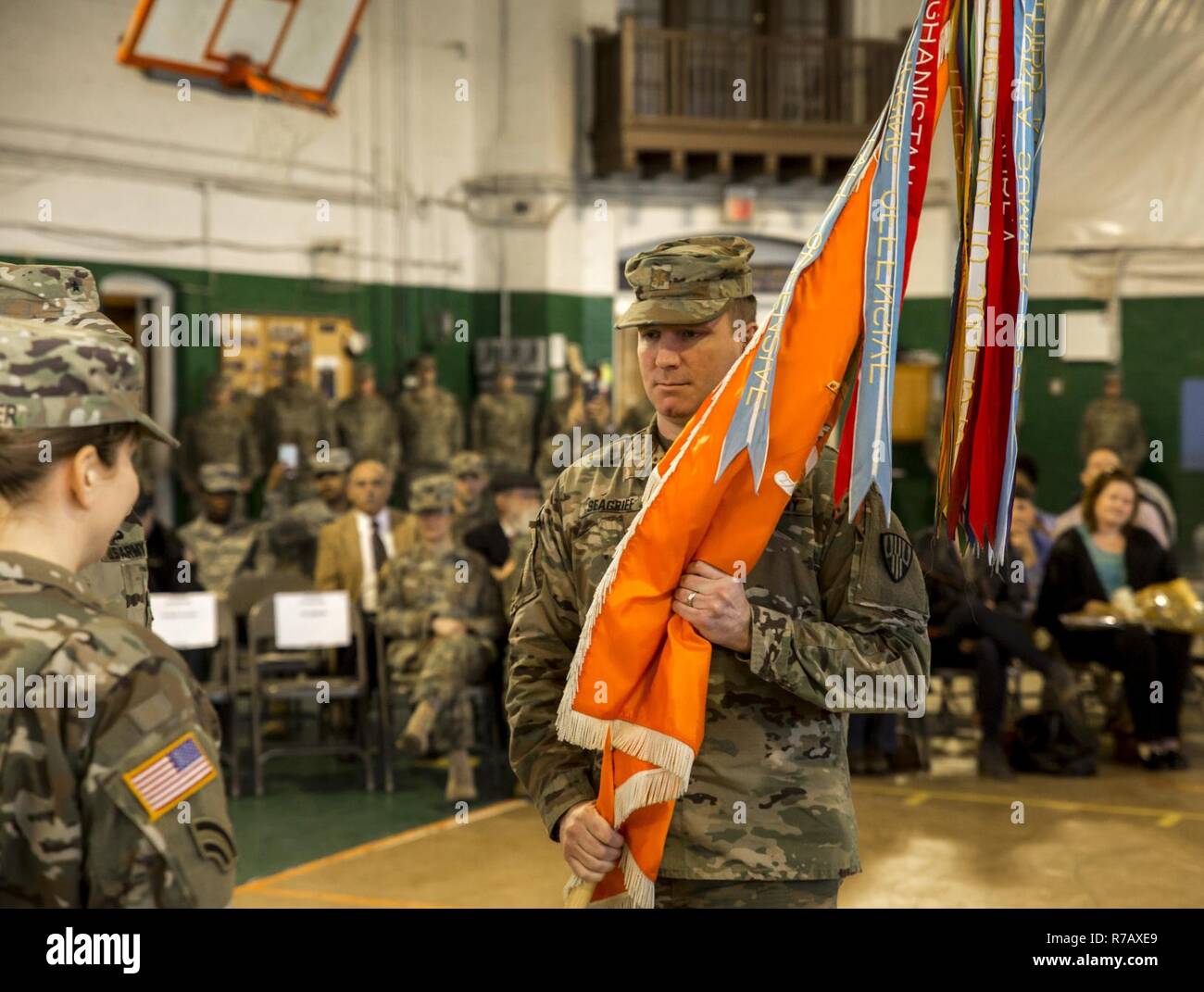 U.S. Army Maj. Ian Seagriff holds the battalion colors as he assumes ...