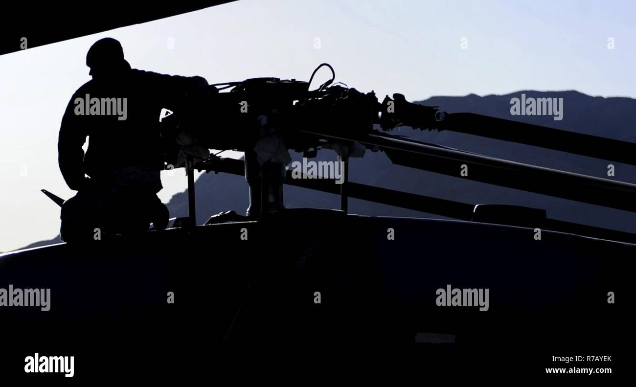 An Airman helps guide the rotor of an HH-60 Pave Hawk assigned to the ...