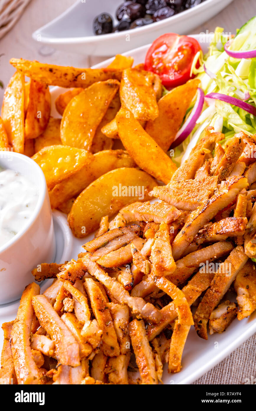 gyros plate with green salad,olives and potato wedges Stock Photo - Alamy