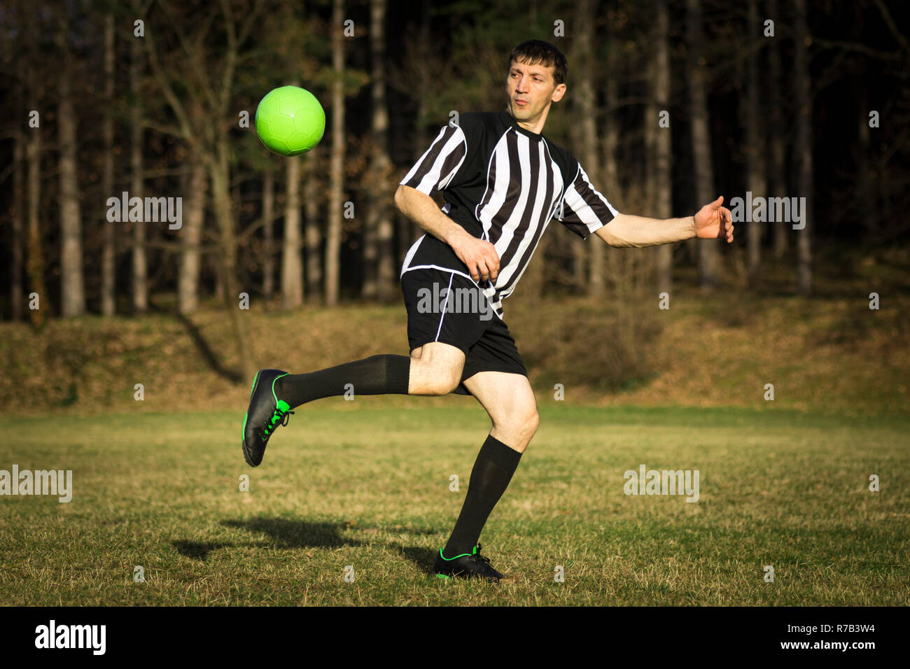 playing soccer player Stock Photo - Alamy