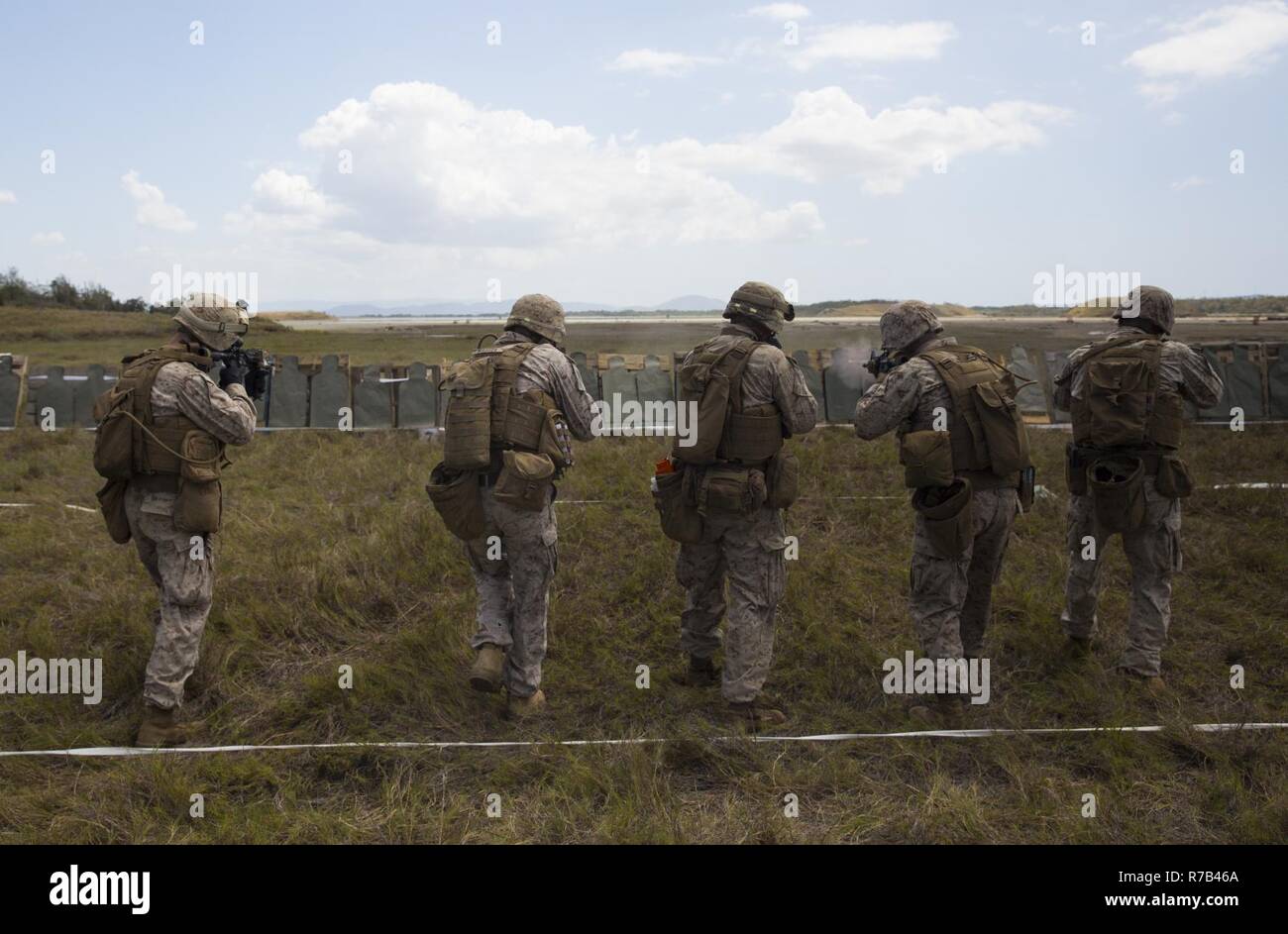 Marines move forward and fire their weapons down range at Naval Station ...