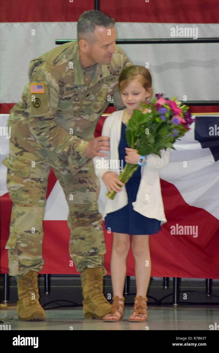 Georgia Army National Guard Lt. Col. Joseph Henson hugs his daughter ...
