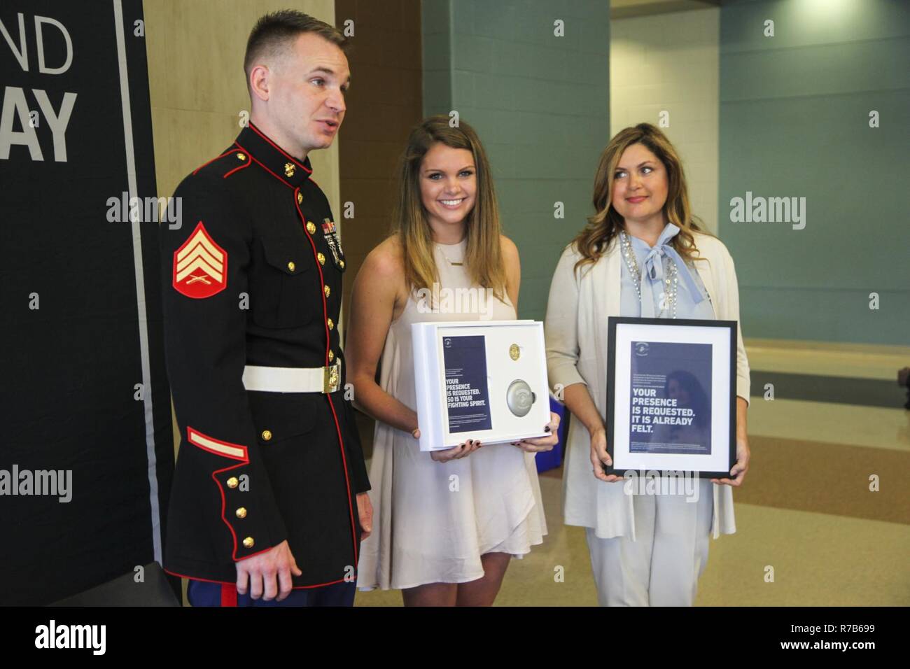 U.S. Marine Sgt. Roderick Evans presents Natasha Kusibab and her mentor ...