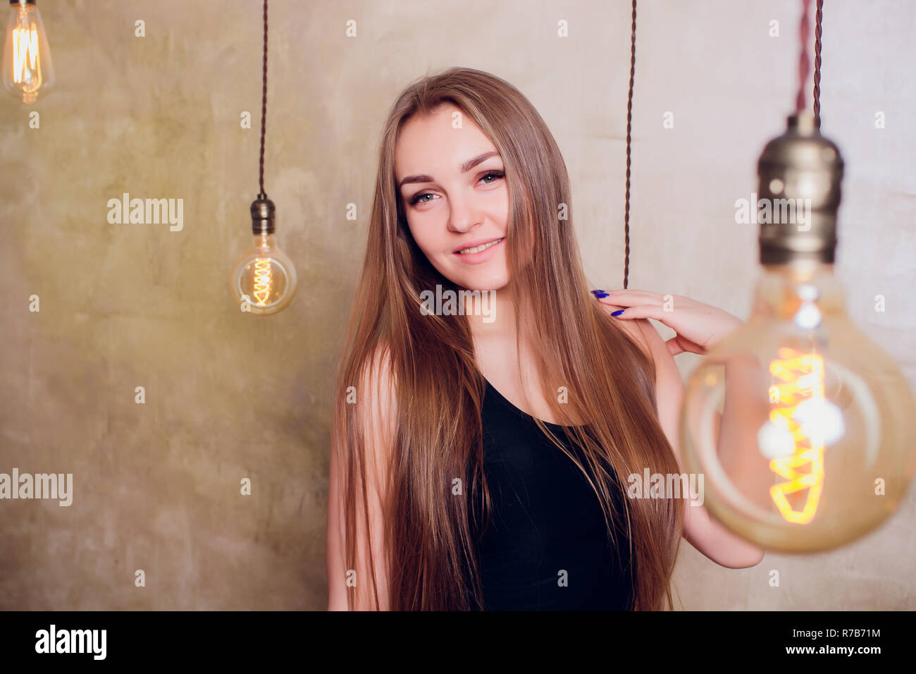 girl electric lamps and brick wall Stock Photo - Alamy