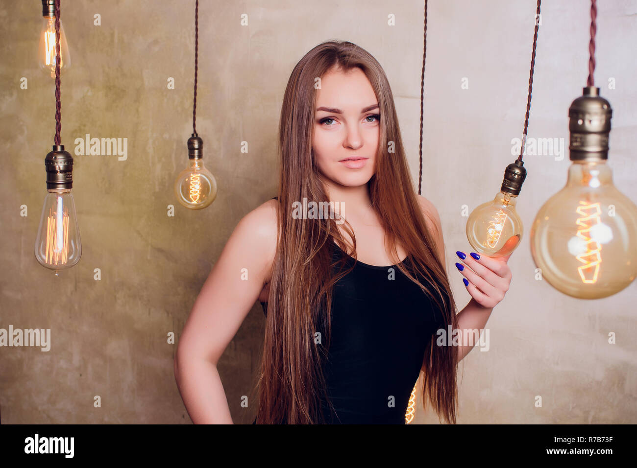 girl electric lamps and brick wall Stock Photo - Alamy