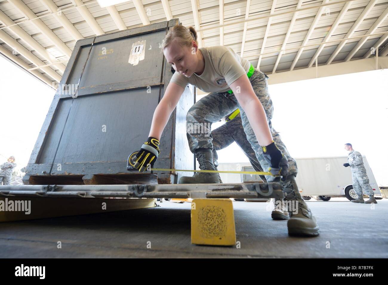 U.S. Air Force Senior Airman Liliya Kampsen measures the cargo ...