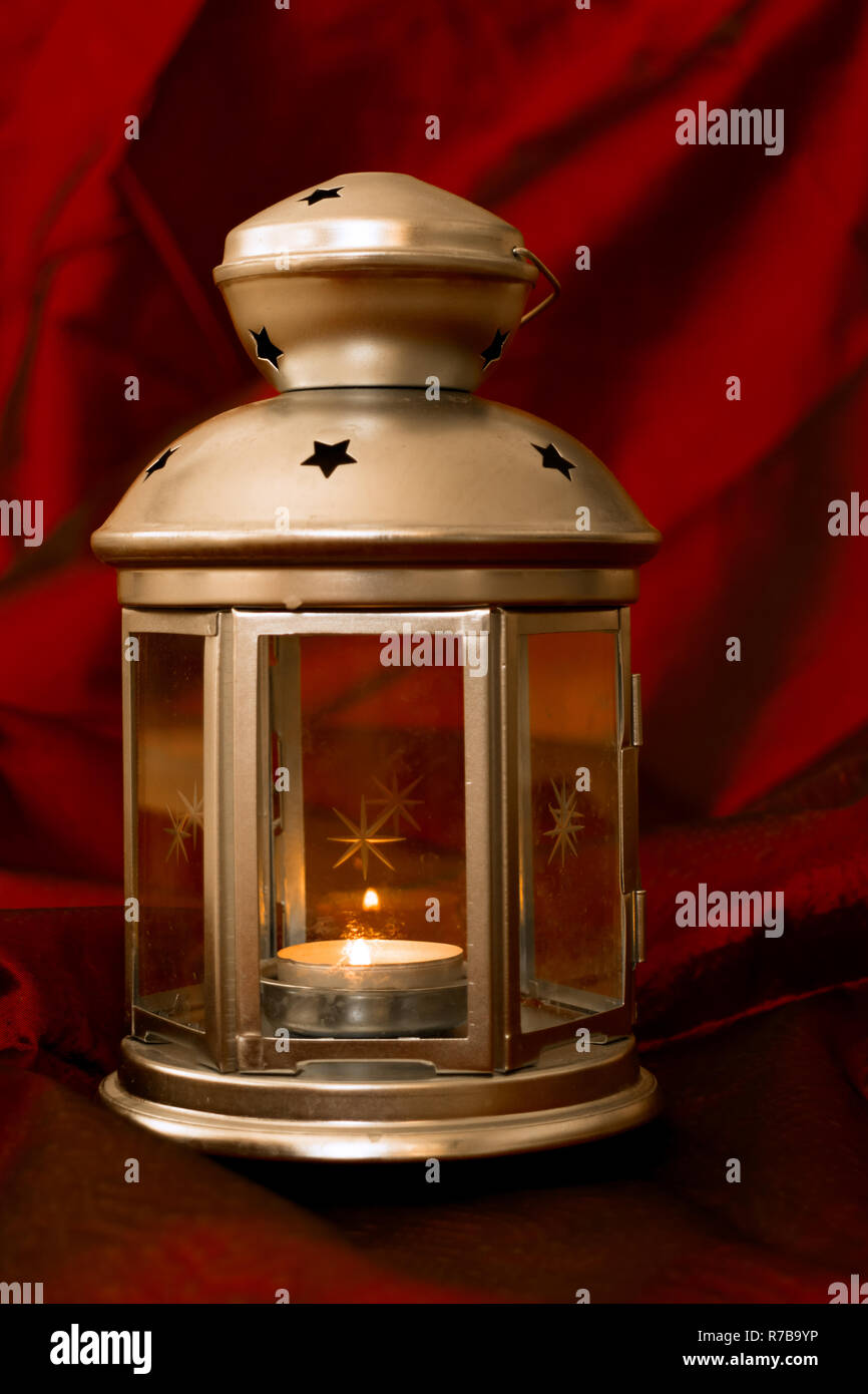 Silver advent lantern on dark red background Stock Photo - Alamy