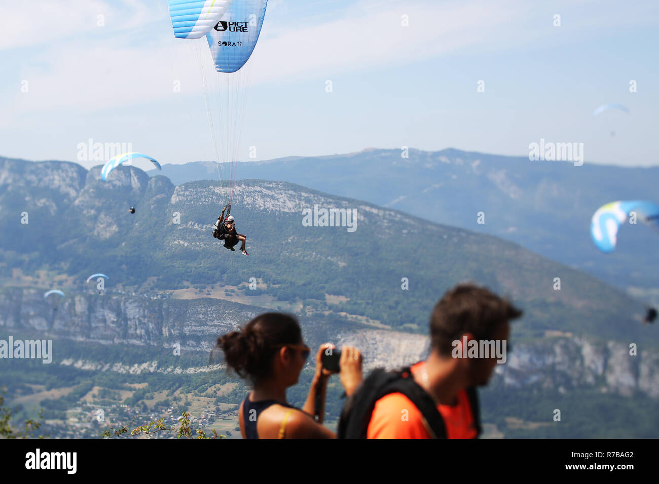 A tandem pilot and his passenger flying in front of Col de la Forclaz ...