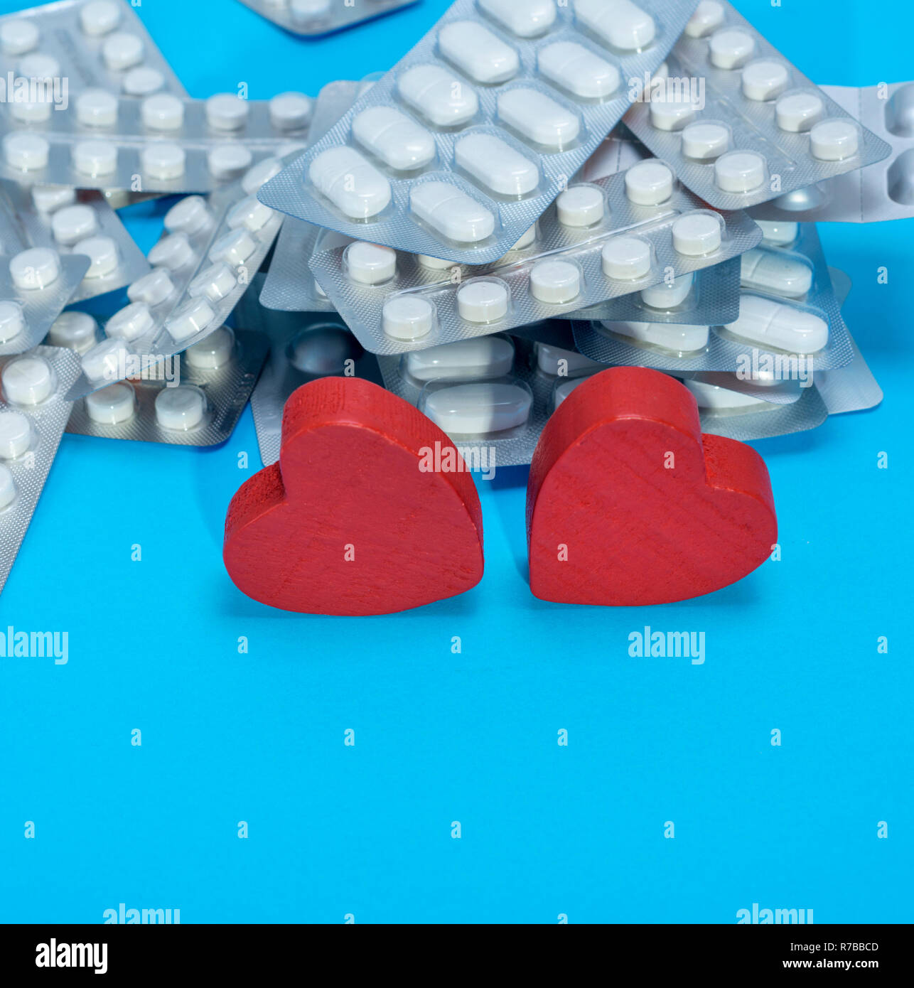 different pills in a package and two red hearts Stock Photo - Alamy