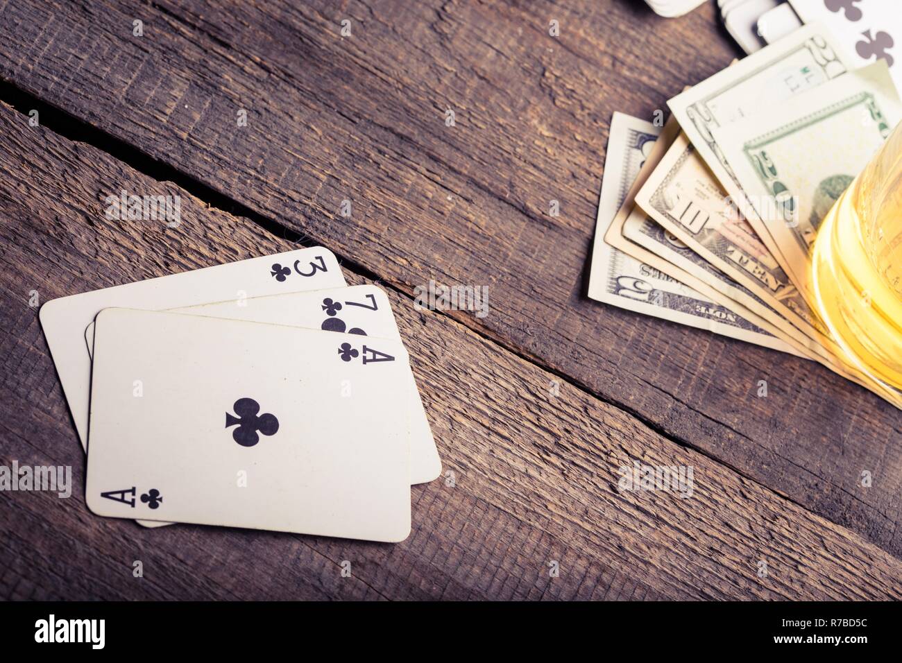 three, seven, ace playing card combination on a wooden table Stock ...