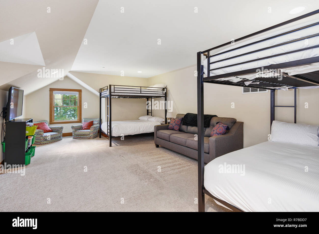 White and grey attic bunk room with vaulted ceiling and lots of space ...
