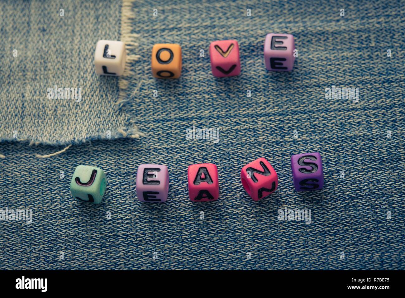 cubes with letters love jeans on a jeans background Stock Photo - Alamy