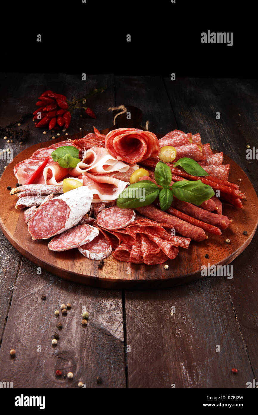 Food tray with delicious salami, pieces of sliced prosciutto crudo ...
