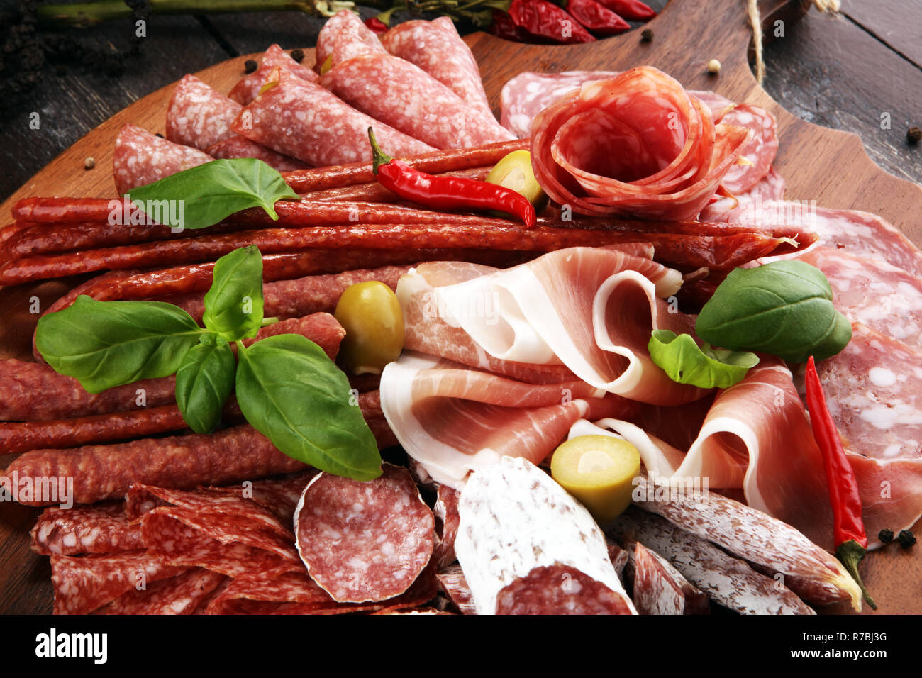 Food tray with delicious salami, pieces of sliced prosciutto crudo ...