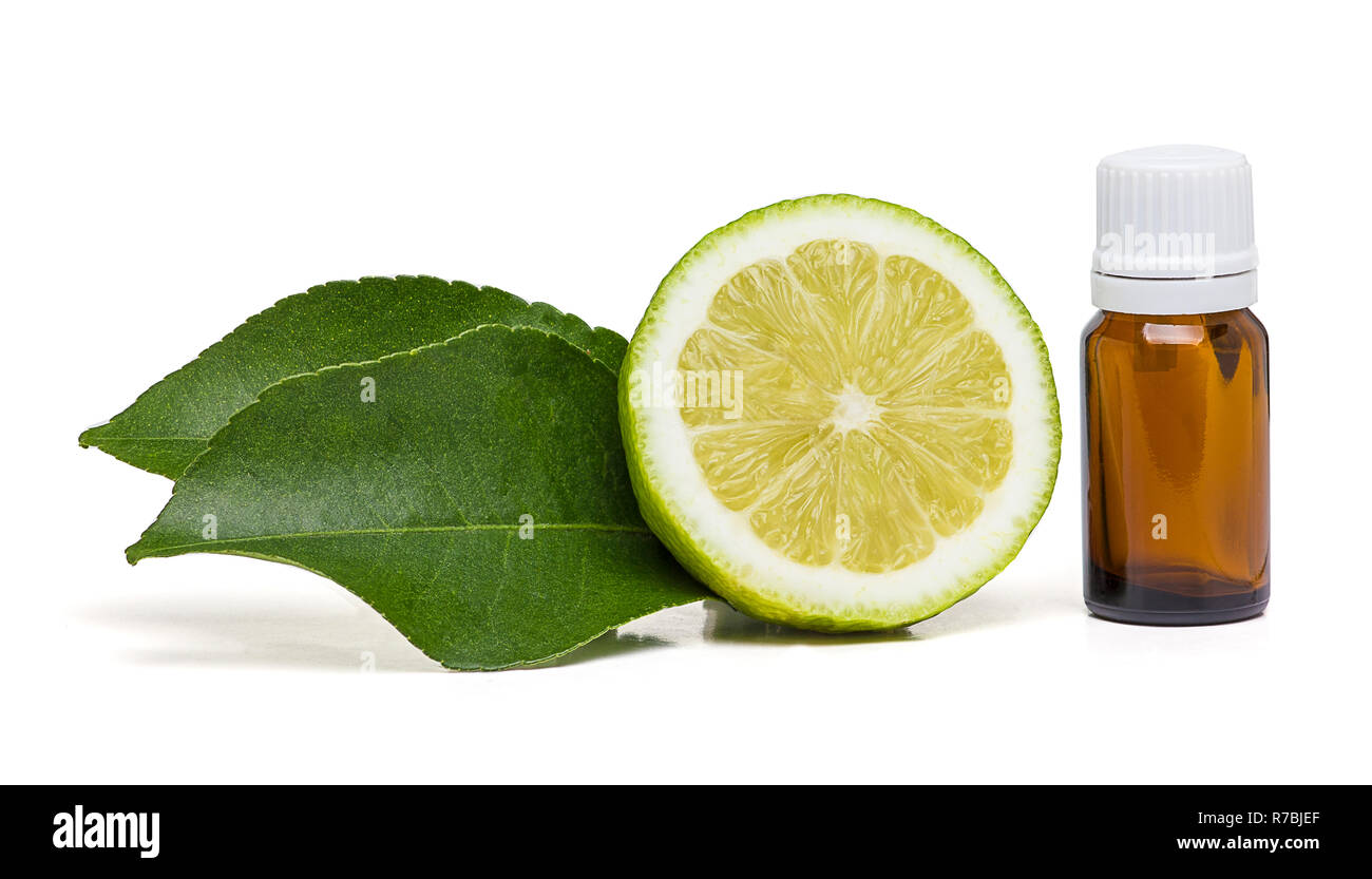 Lemon essential oil with a half lemon fruit and two side leaves ...