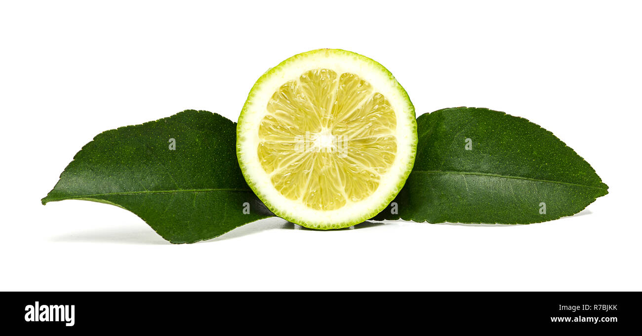 Half lemon fruit with two green leaves isolated on with background ...