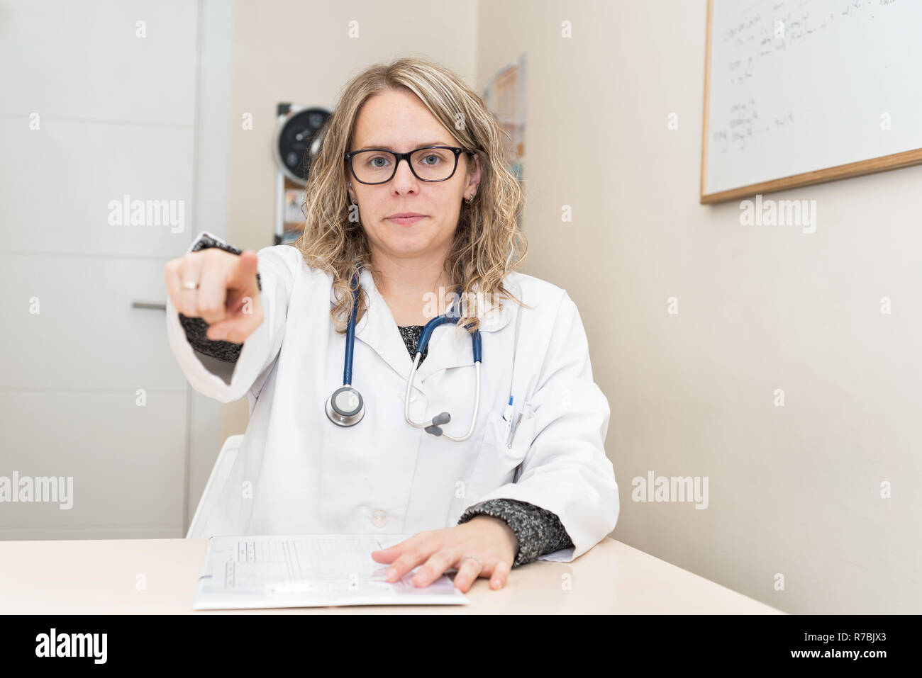 Female doctor pointing at you with serious expression Stock Photo - Alamy