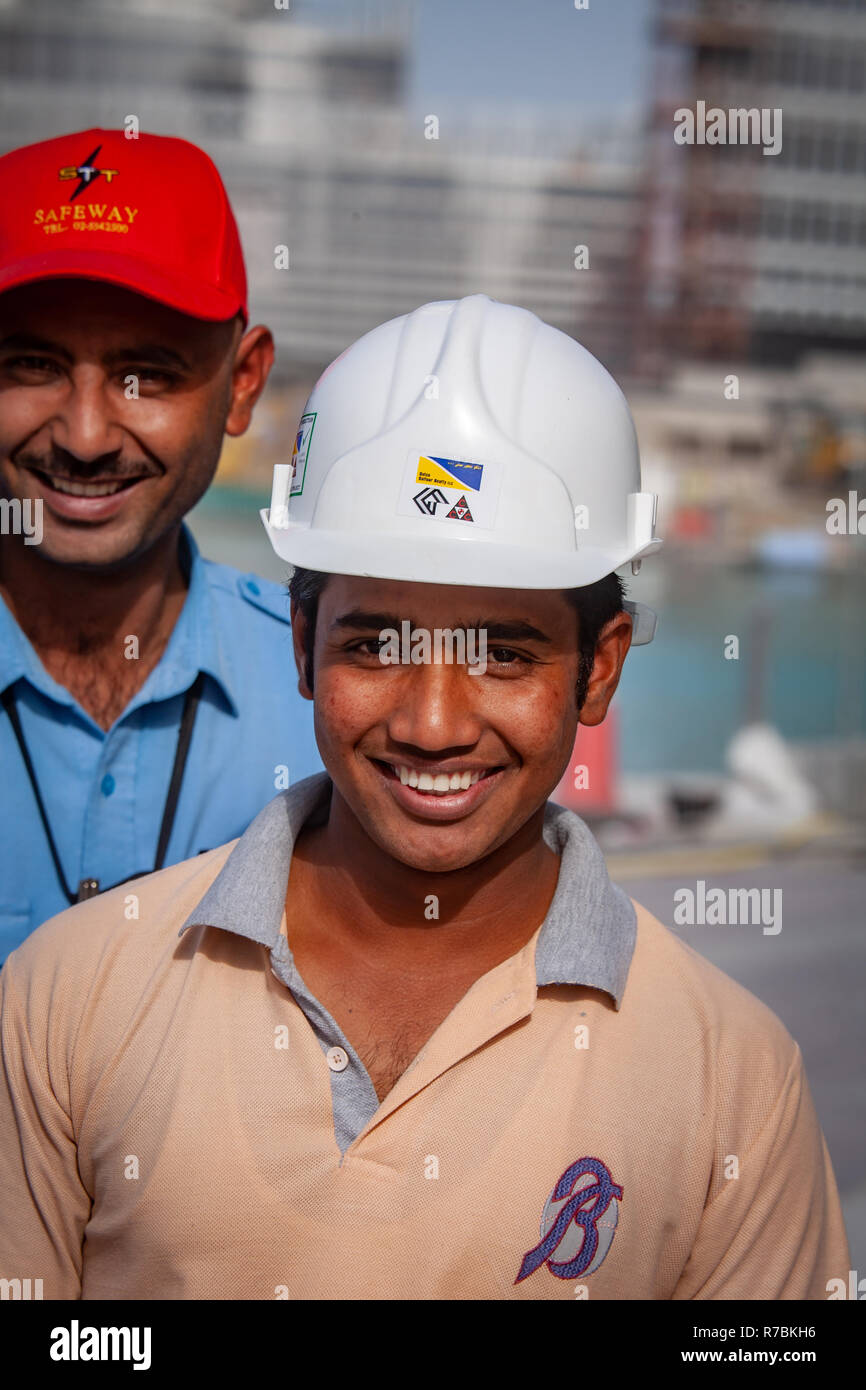 Two building Workers relaxing at a building site in Dubai, UAE Stock ...