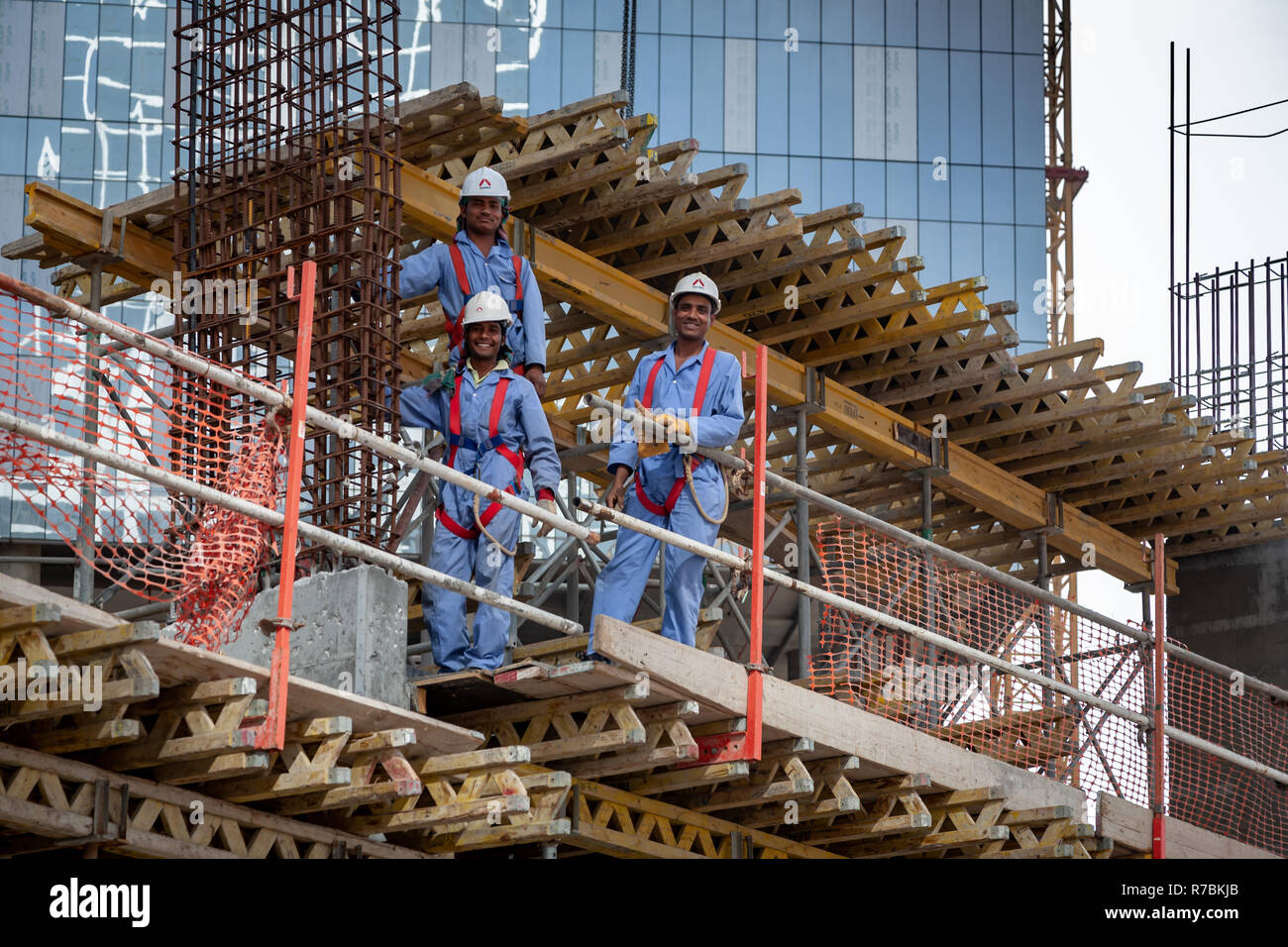 Three building workers up on scaffold on building site in Dubai Stock ...
